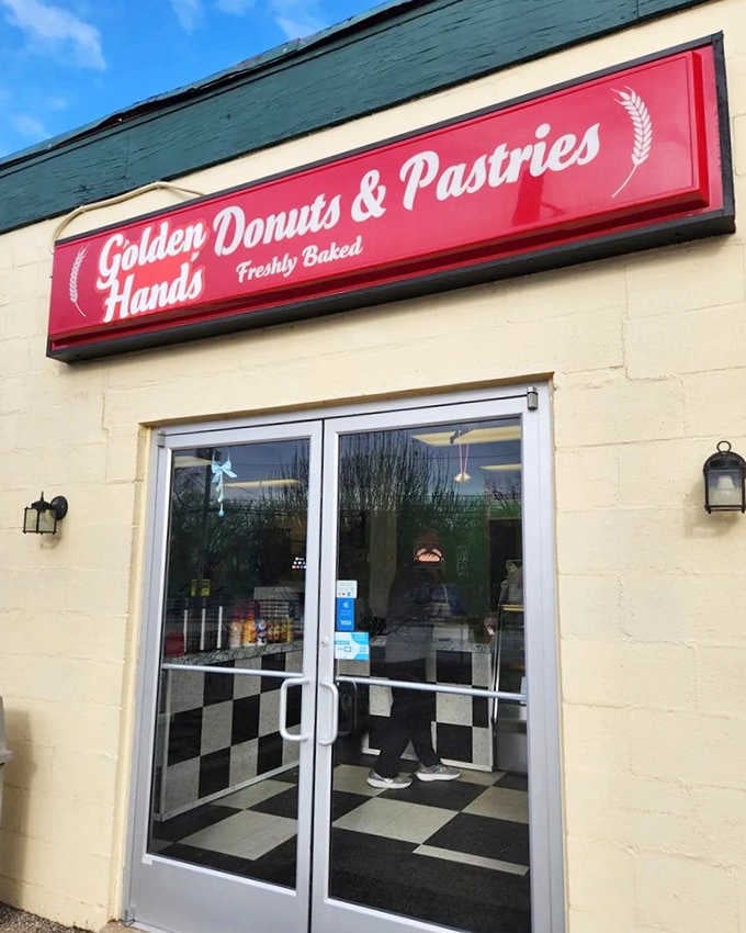 The classic black-and-white checkered floor peeking through those glass doors at Golden Hands says retro charm meets fresh-baked goodness.