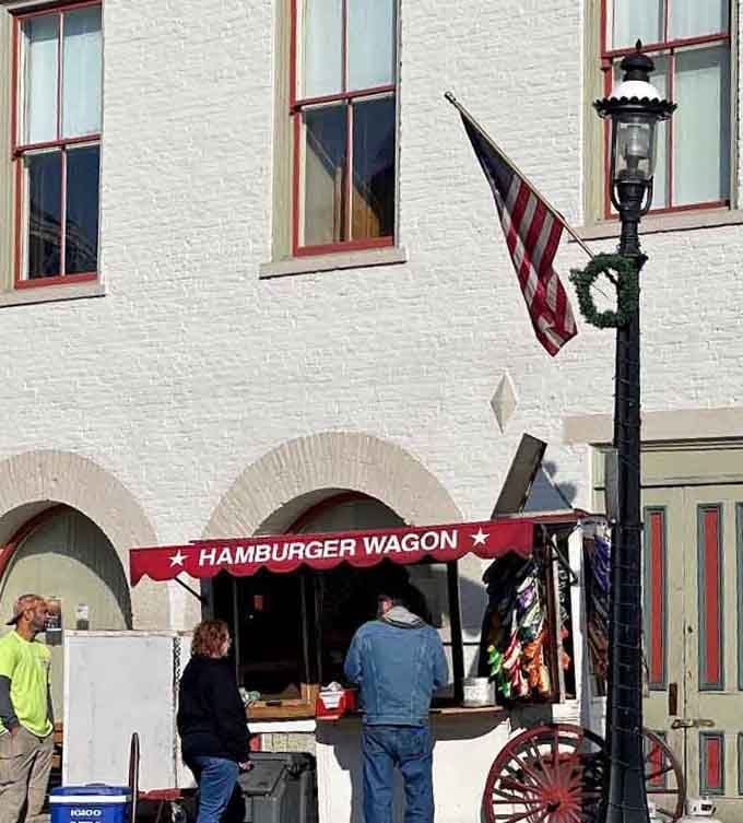 Gathered beneath an American flag and a gas lamp, hungry folks at the Hamburger Wagon know patience tastes wonderful.
