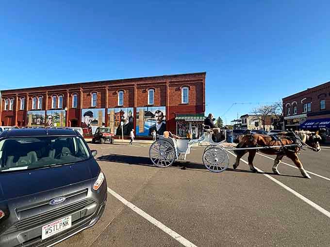 A horse-drawn carriage shares the road with cars, blending past and present beautifully together.
