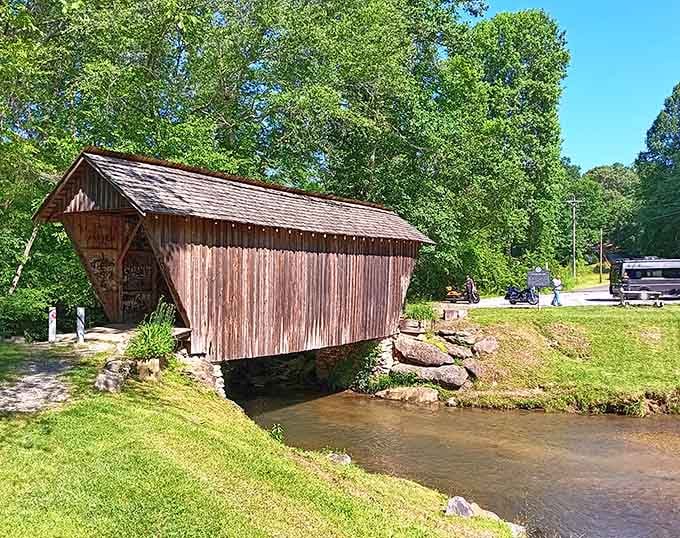 Faded red siding gives this bridge the look of a well-loved barn that decided crossing creeks was its true calling.