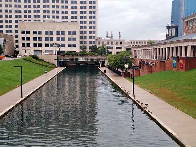 The canal's glassy surface mirrors the city skyline so crisply, Indianapolis looks like it's showing off a little.