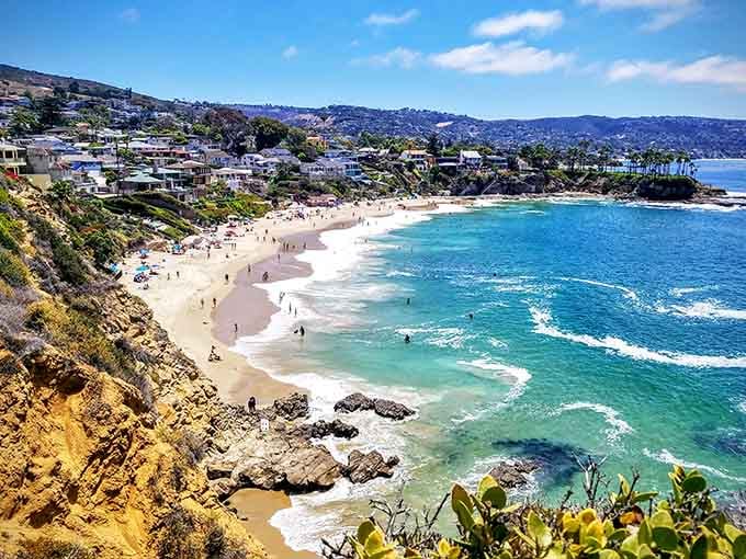 That turquoise water curving around golden cliffs makes every other beach feel like it owes you an apology.