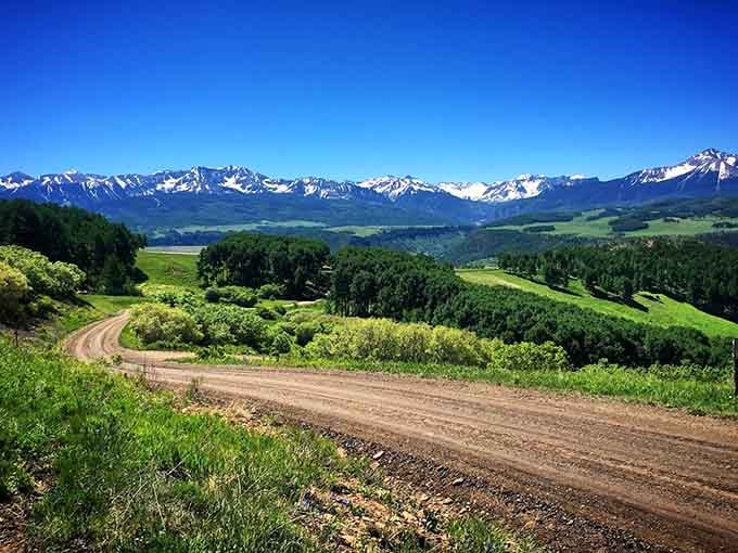 Rolling green hills meet snow-capped peaks along this scenic byway, where every curve reveals another reason to stop.