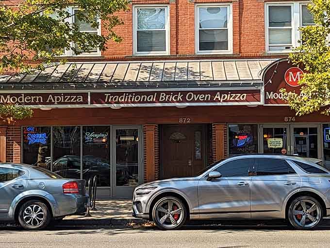 Autumn leaves frame the Traditional Brick Oven Apizza awning on State Street like a painting you could eat.