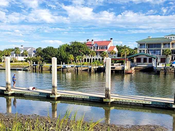 A lone fisherman, a calm dock, and waterfront homes that make you rethink every life decision you've ever made.