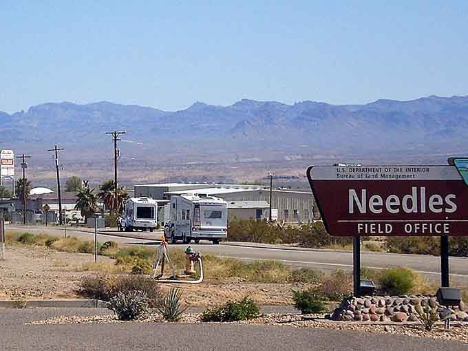 RVs rolling past the Needles Field Office sign say it all: the desert life is calling, and people are answering.