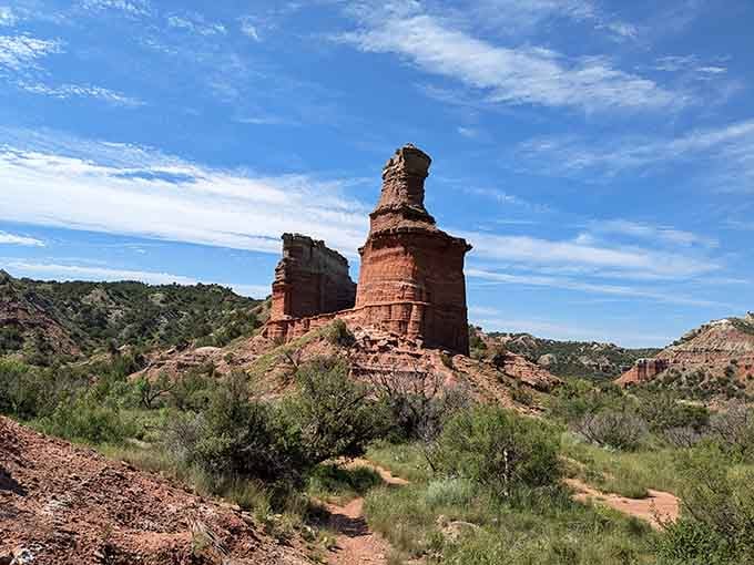 The dusty trail leading toward the Lighthouse rock formation at Palo Duro Canyon proves the best rewards require a little walking.