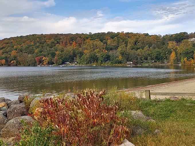 Crimson foliage frames Squantz Pond's calm surface, reminding you that Connecticut fall foliage is absolutely no joke.