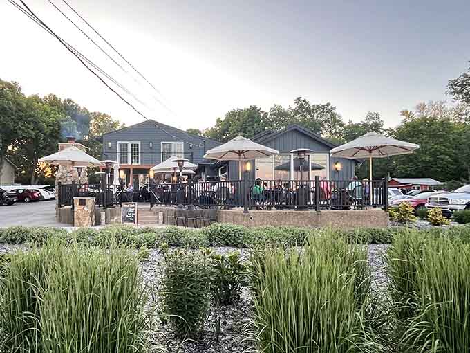 Lush landscaping frames the scene perfectly, proof that great atmosphere starts long before you sit down.