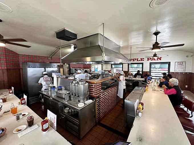 White-uniformed cooks working around that open brick kitchen at The Apple Pan make every order feel like a personal performance just for you.