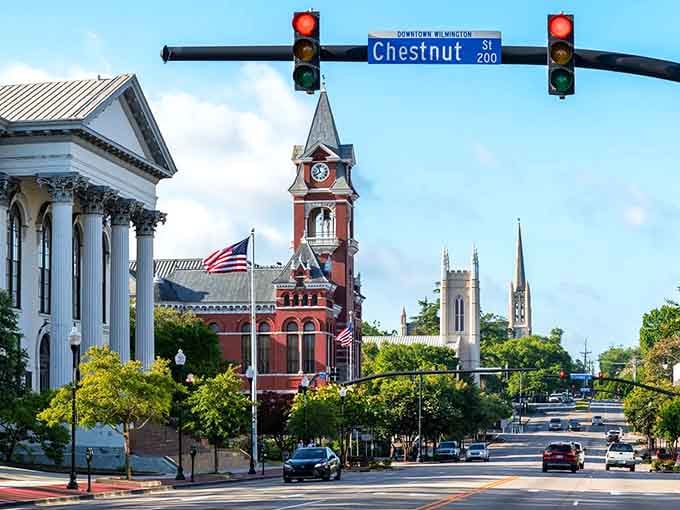 That red brick clock tower stands proud against blue skies like a postcard from a gentler era.