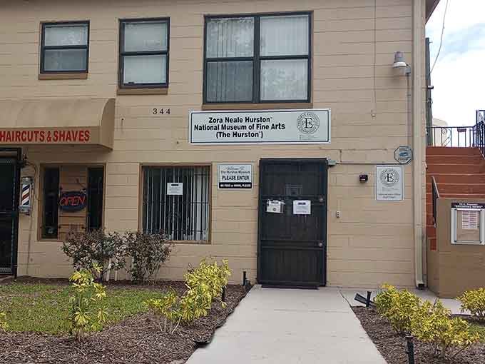 A simple "Please Enter" sign on a modest building holds more cultural significance than most grand museum facades ever will.