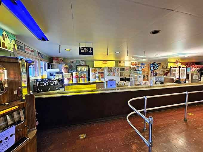 The snack bar counter is long, well-lit, and ready for business. Hot buttered popcorn is already calling your name.