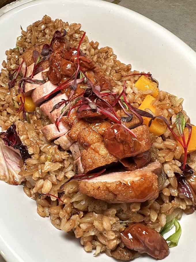 Sliced duck breast fanned over nutty rice delivers the kind of elegance that doesn't require a tuxedo to enjoy.