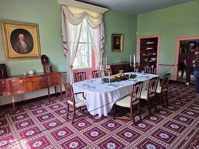 Candlesticks, a formal table setting, and a portrait on the wall make this dining room feel genuinely dinner-party ready.