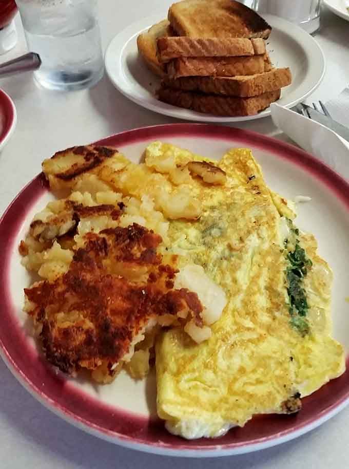 A spinach and cheese omelette with beautifully browned home fries and thick toast, this is the breakfast that earns your loyalty.
