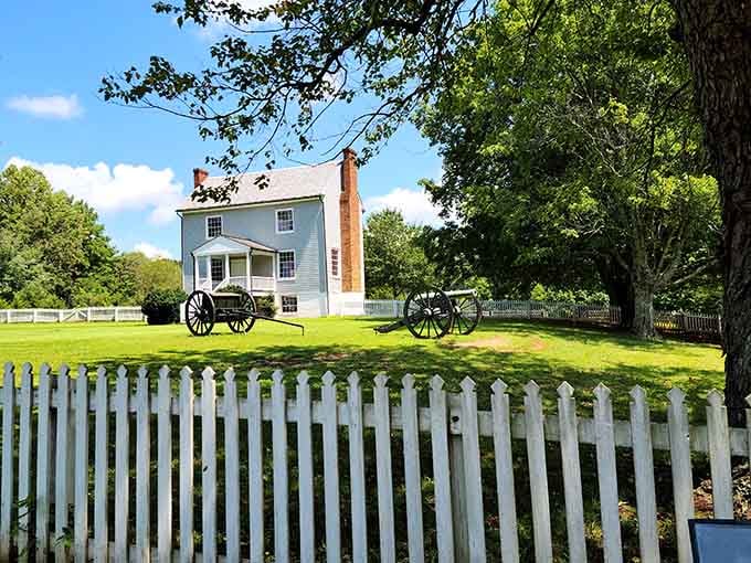 Artillery pieces parked on a summer lawn serve as a gentle reminder that this peaceful village once held its breath.