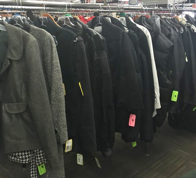 A rack full of coats and jackets, because Minnesota winters don't care about your budget, but this store does.