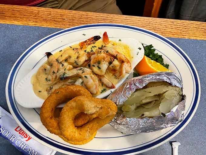 Jumbo shrimp swimming in scampi sauce with a baked potato on the side. Tuesday never looked this good.