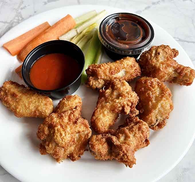 Crispy, golden, and unapologetically satisfying, these wings arrive with dipping sauces that mean serious business.