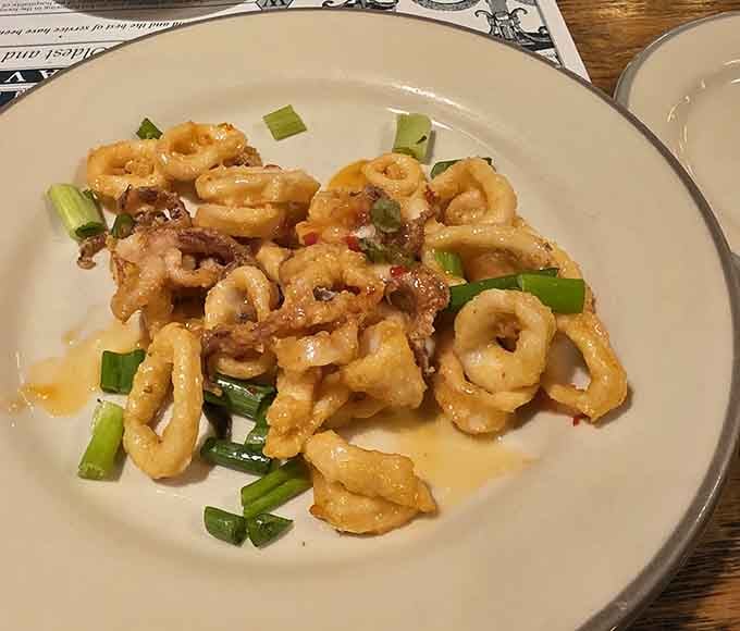 Calamari with sweet chili glaze and scallions. Tender, golden, and gone faster than you planned. Every time.