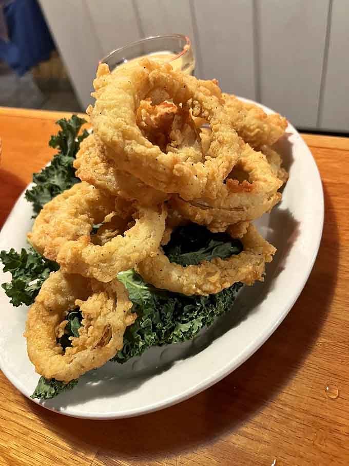 These onion rings are crispy, golden perfection that could make a vegetarian reconsider their entire life philosophy.