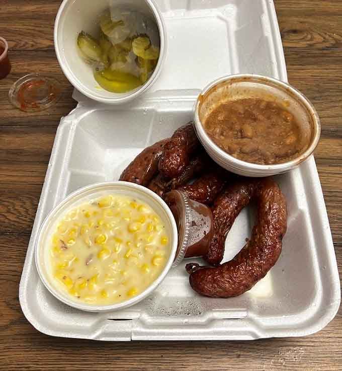 Links of homemade sausage flanked by creamed corn and beans, this tray is pure, unapologetic Texas comfort food.