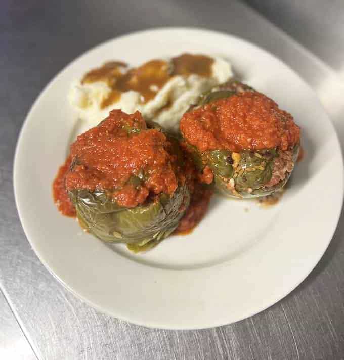 Two stuffed peppers sitting in tomato sauce like they own the place. Honestly, they kind of do.