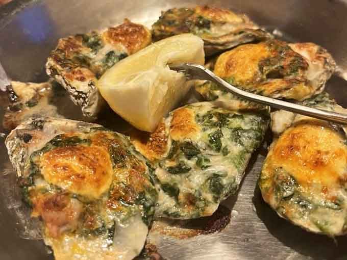 Oysters Rockefeller, bubbling and golden, with a squeeze of lemon waiting patiently on the side. Pure, unapologetic indulgence on a shell.
