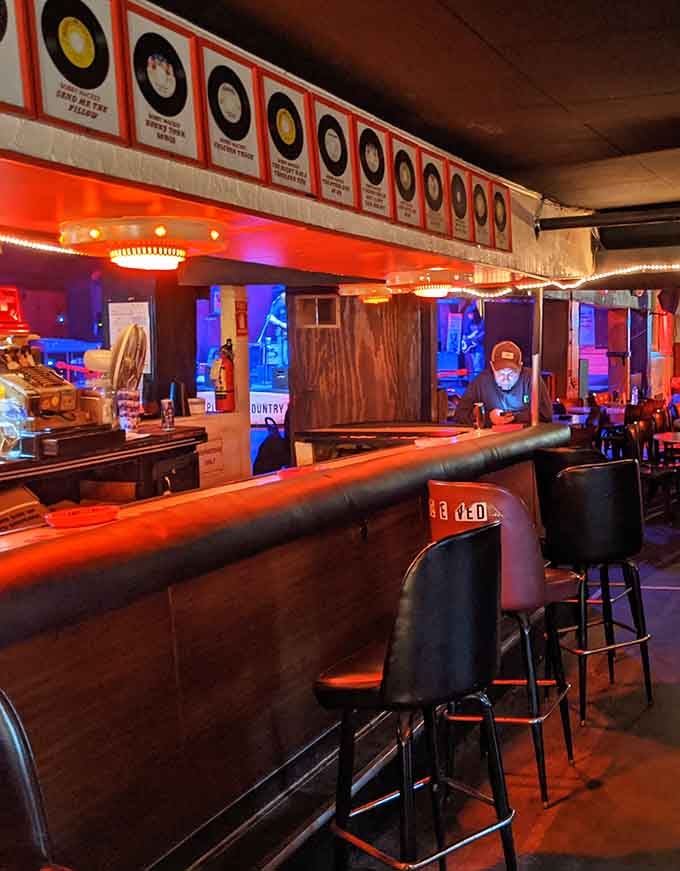 Vintage records line the walls above a classic bar where countless conversations have unfolded over cold ones.