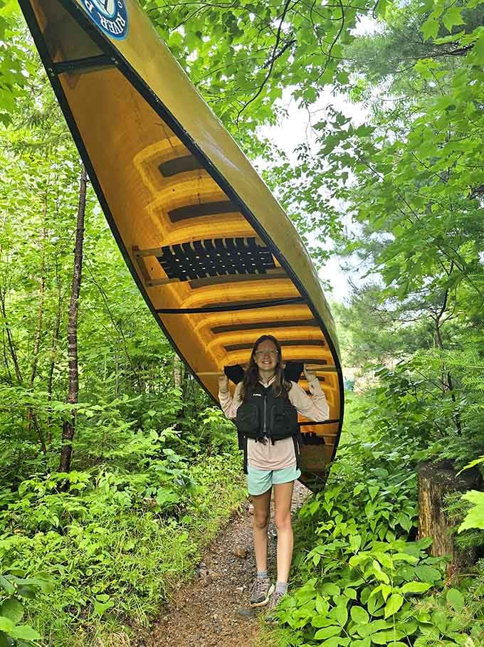 Portaging a canoe through the woods builds character, strong arms, and a very good story for later.