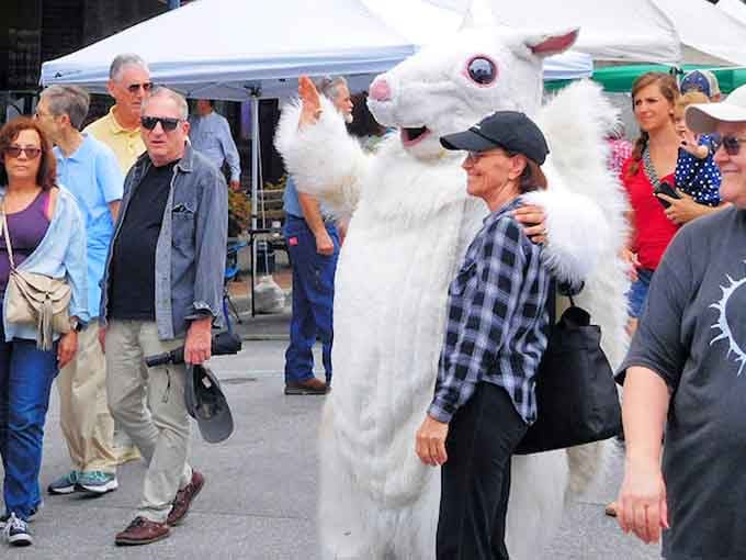 The White Squirrel Festival mascot works the crowd like a seasoned politician at a county fair.
