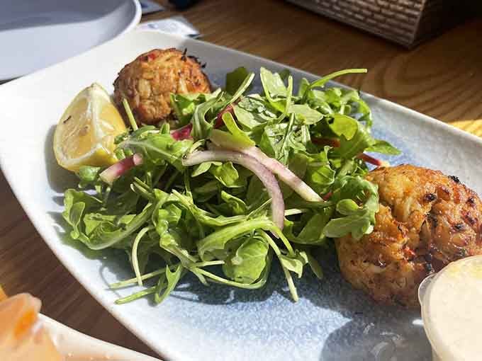 Arugula never looked so happy. These crab cakes with fresh greens and lemon are proof that simple things done well win every time.