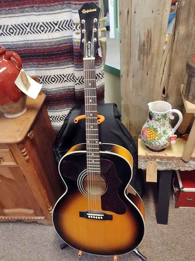 A sunburst Epiphone acoustic guitar leaning casually in the corner, as if it's just waiting for the right person to notice.