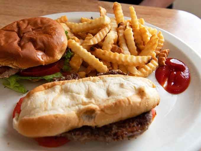 A burger and a pork tenderloin sandwich sharing one plate with crinkle fries &mdash; this is what a good day looks like.