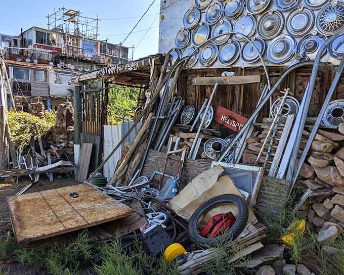 Scrap metal, old wheels, and salvaged materials wait patiently here, future building blocks for a castle that never stops growing.
