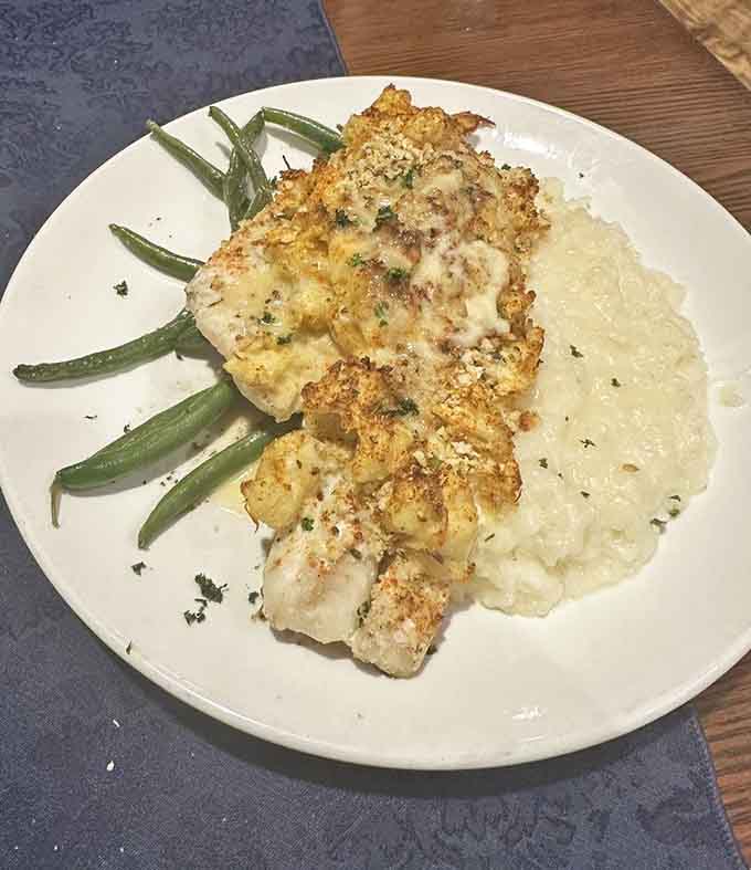 Crab-crusted perfection with green beans and mashed potatoes, this is the kind of plate that makes you slow down and savor.