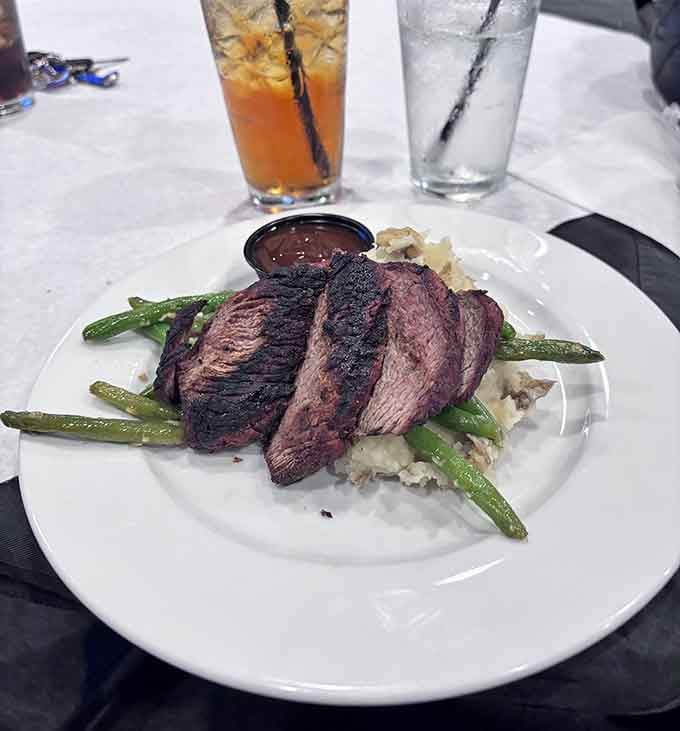 Sliced steak over creamy mash and green beans is comfort food elevated to an art form.