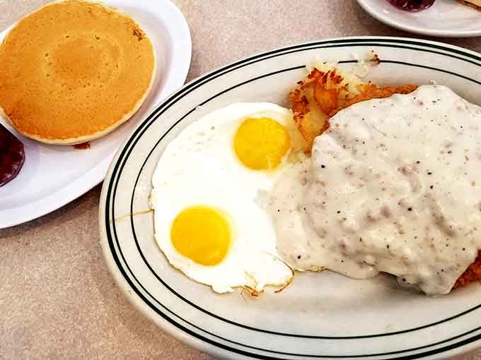 Country fried steak smothered in peppery gravy with sunny-side eggs is comfort food that would make your grandmother proud.