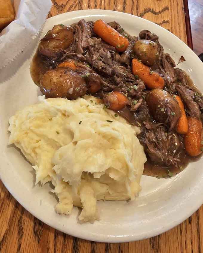 Tender pot roast, sweet carrots, baby potatoes, and a cloud of mashed potatoes. This plate is basically a warm hug.