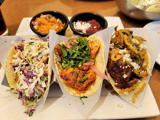 Three tacos lined up like the greatest starting lineup you've ever seen on a corn tortilla.