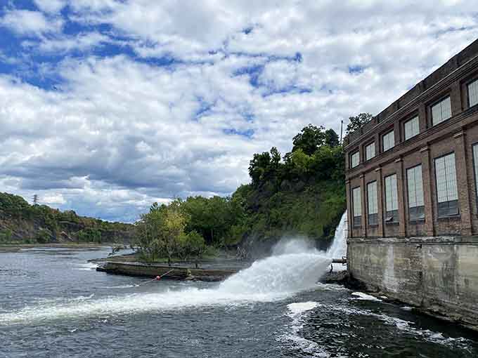 That old powerhouse building stands as a reminder of when waterfalls actually punched the clock daily.