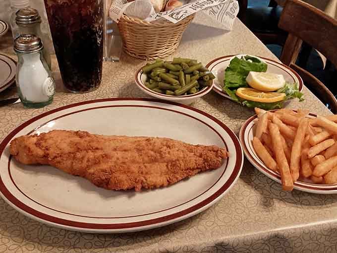 One magnificent breaded fish fillet, fries, and green beans. Simple, honest, and absolutely impossible to argue with.