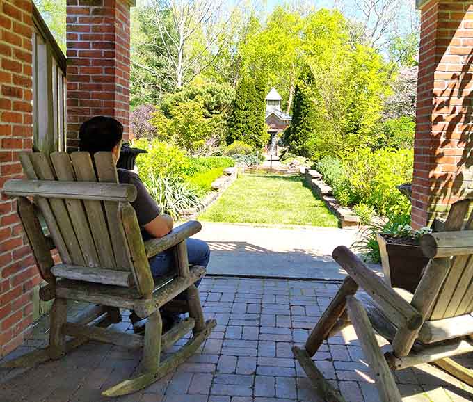 Rocking chairs facing a garden this beautiful. Whoever designed this seating arrangement deserves an award.
