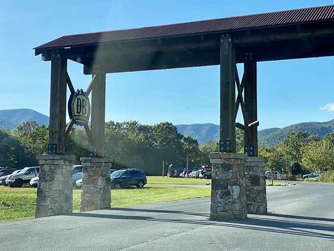 Stone pillars, a rustic roof, and mountains beyond. This entrance means business, and that business is a very good time.