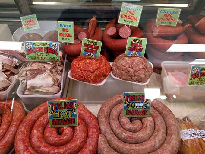 Italian hot sausage, fresh garlic sausage, and ring bologna sharing one case like old friends at a reunion.