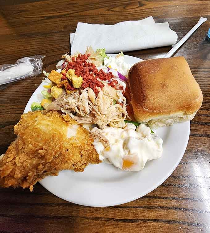 Crispy fried chicken, pulled meat, a fresh roll, and creamy salad, this plate tells you everything you need to know.