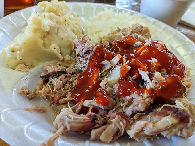 Pulled pork draped in sauce alongside fluffy mashed potatoes, simple, honest, and absolutely impossible to argue with.