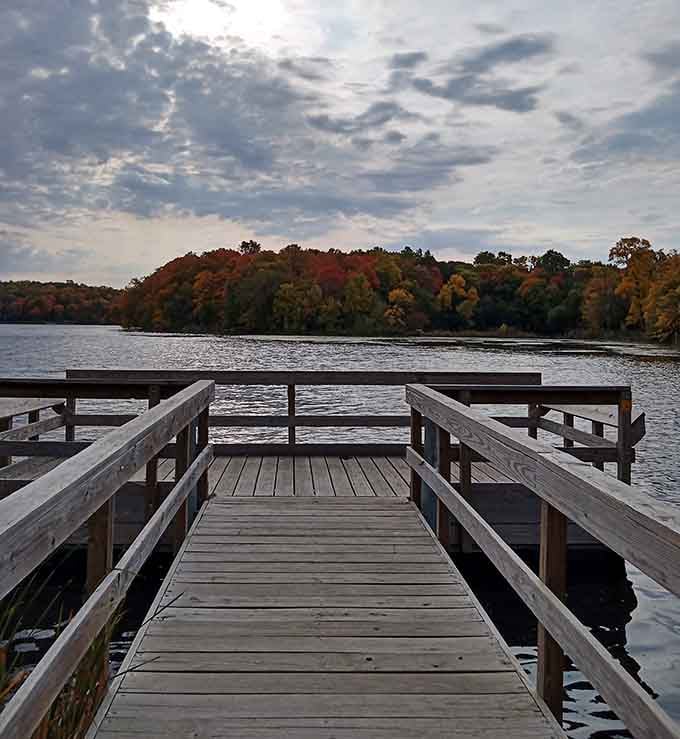 Standing on this wooden pier with fall colors blazing across the water is genuinely hard to improve upon.