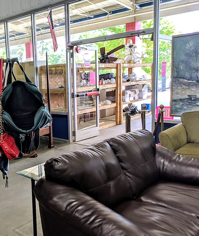 Handbags dangling, leather sofa waiting, framed art leaning nearby, the exit area alone could furnish a very stylish small apartment.